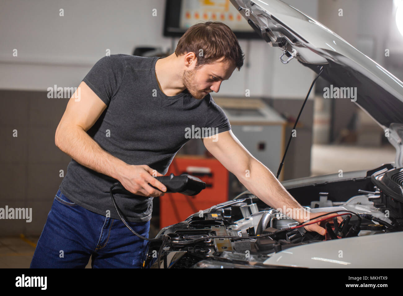 Auto mechanic testing electrical system on automobile Stock Photo - Alamy