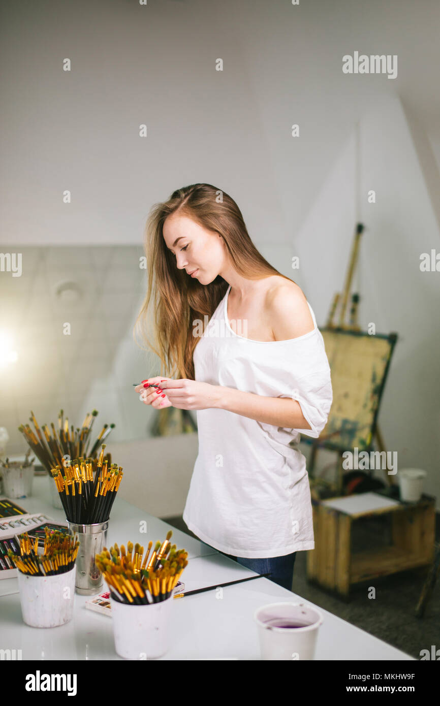 Painting teacher in her studio preparing to an art class Stock Photo ...