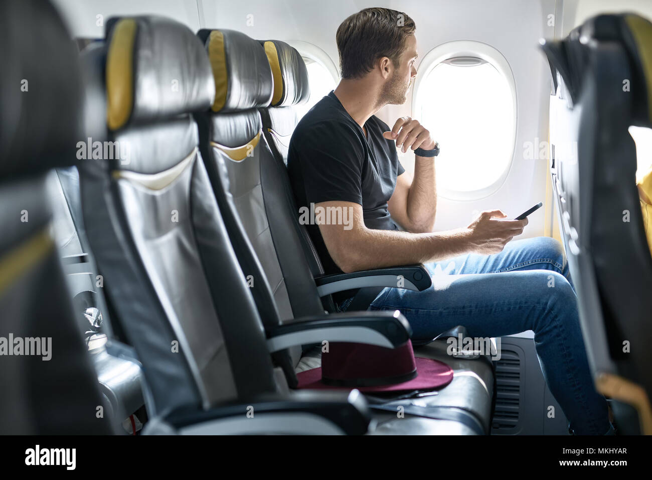 Handsome guy in airplane Stock Photo - Alamy