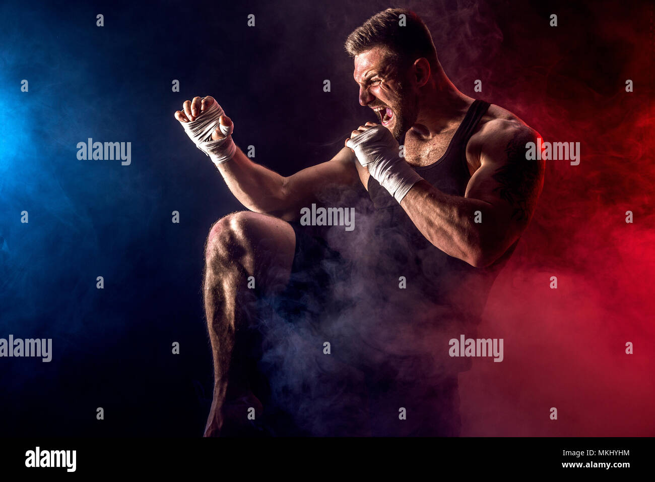 Sport concept. Sportsman muay thai boxer fighting on black background ...