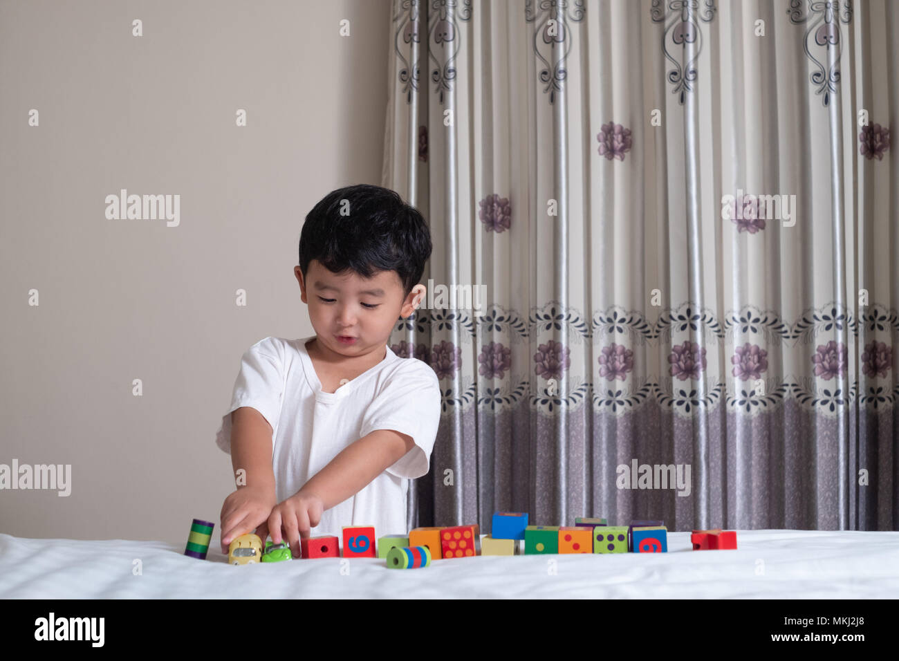 3 years old little cute Asian boy play toy or square block puzzle at ...