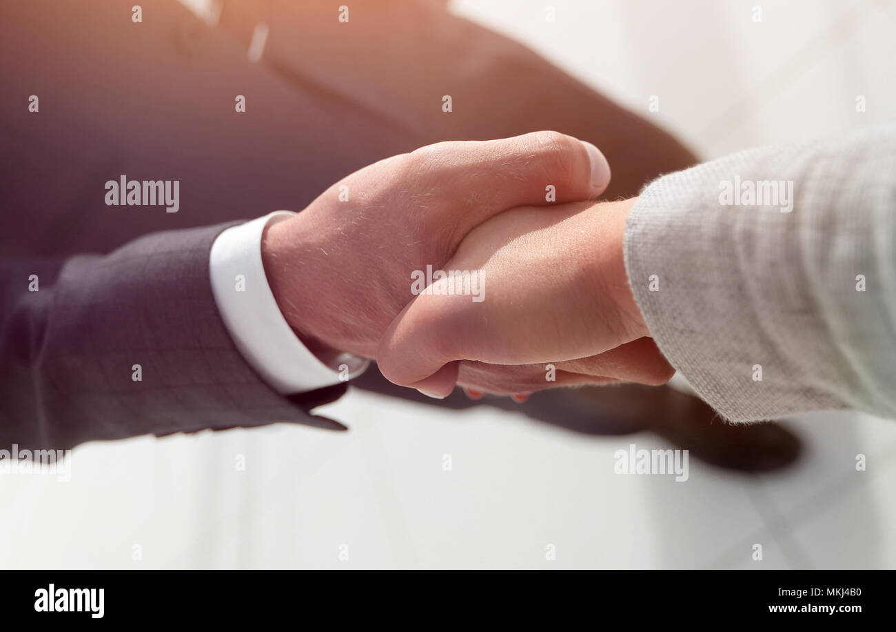 Excited smiling businessman handshaking partner at meeting Stock Photo ...