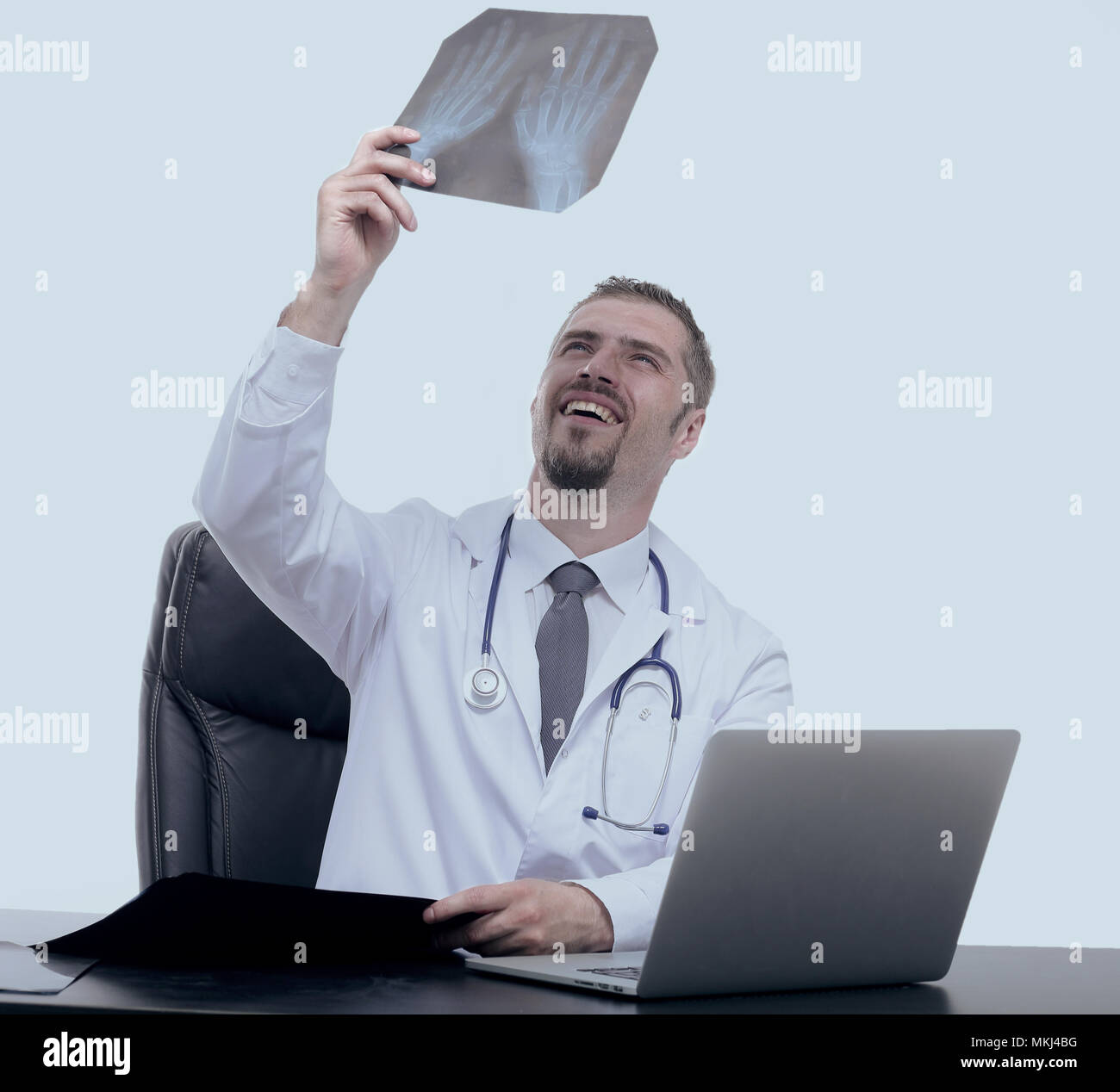 doctor examines an x-ray,sitting behind a Desk Stock Photo - Alamy