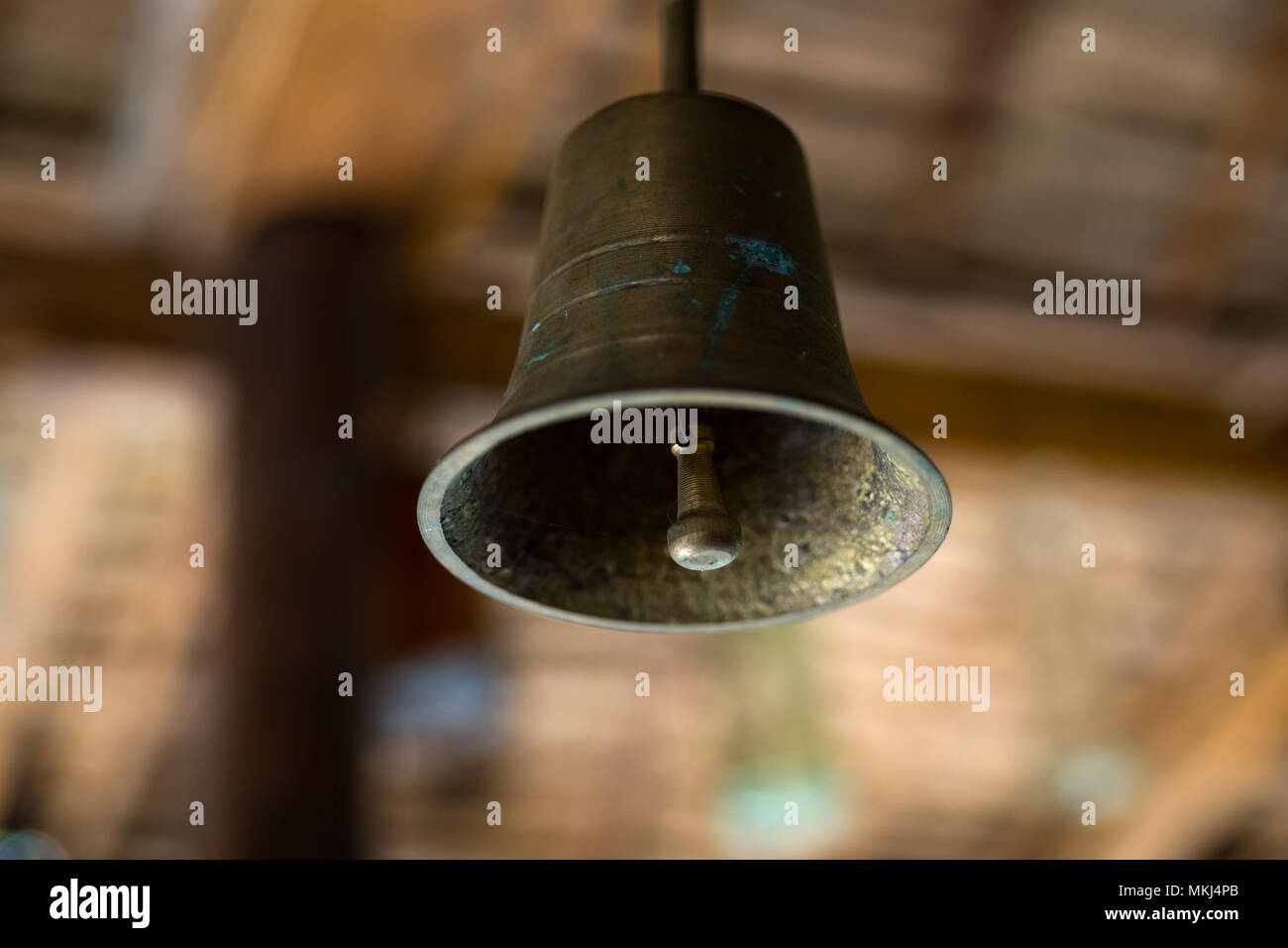 Bronze ring bell hanged under the wooden roof Stock Photo - Alamy