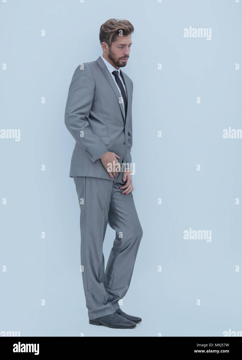 side view of an arrogant stylish man in suit Stock Photo - Alamy
