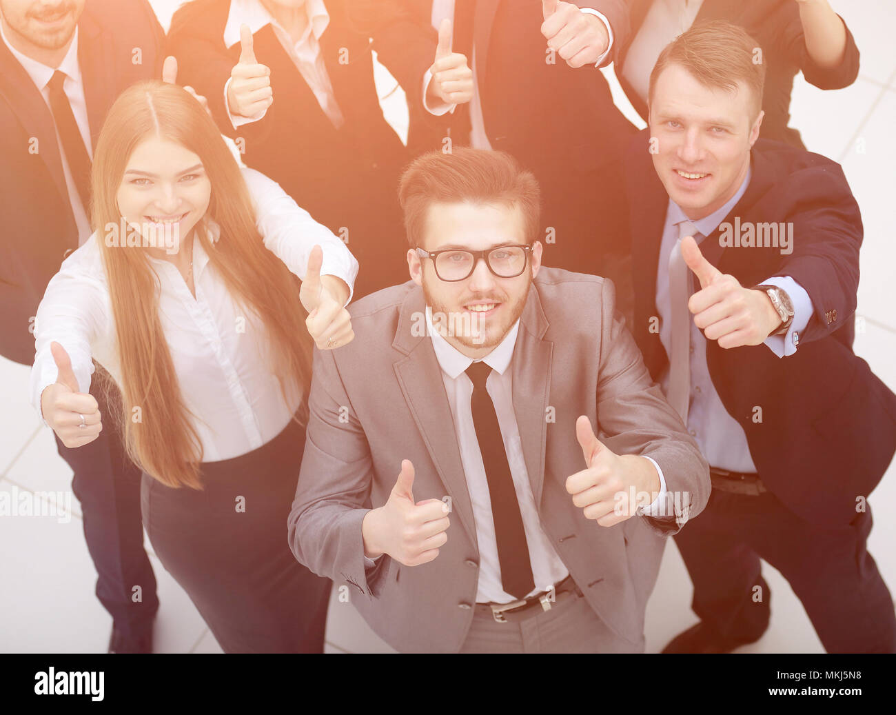 triumphant business team raised a thumbs up Stock Photo - Alamy