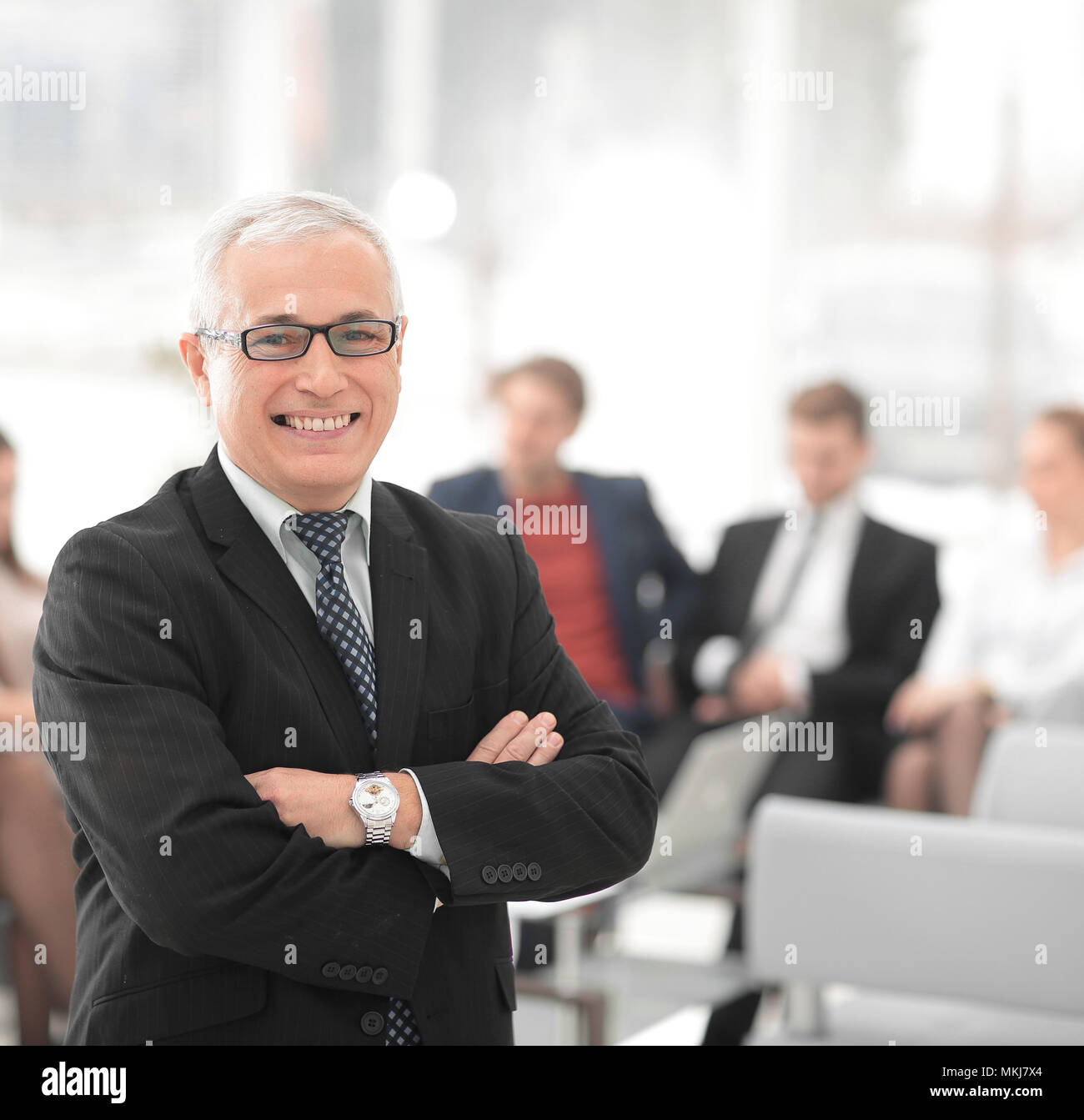 smiling senior boss in the background of the office Stock Photo - Alamy