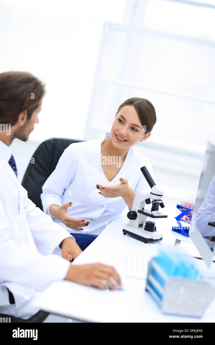 Side view of two scientists conducting a chemical experiment Stock ...