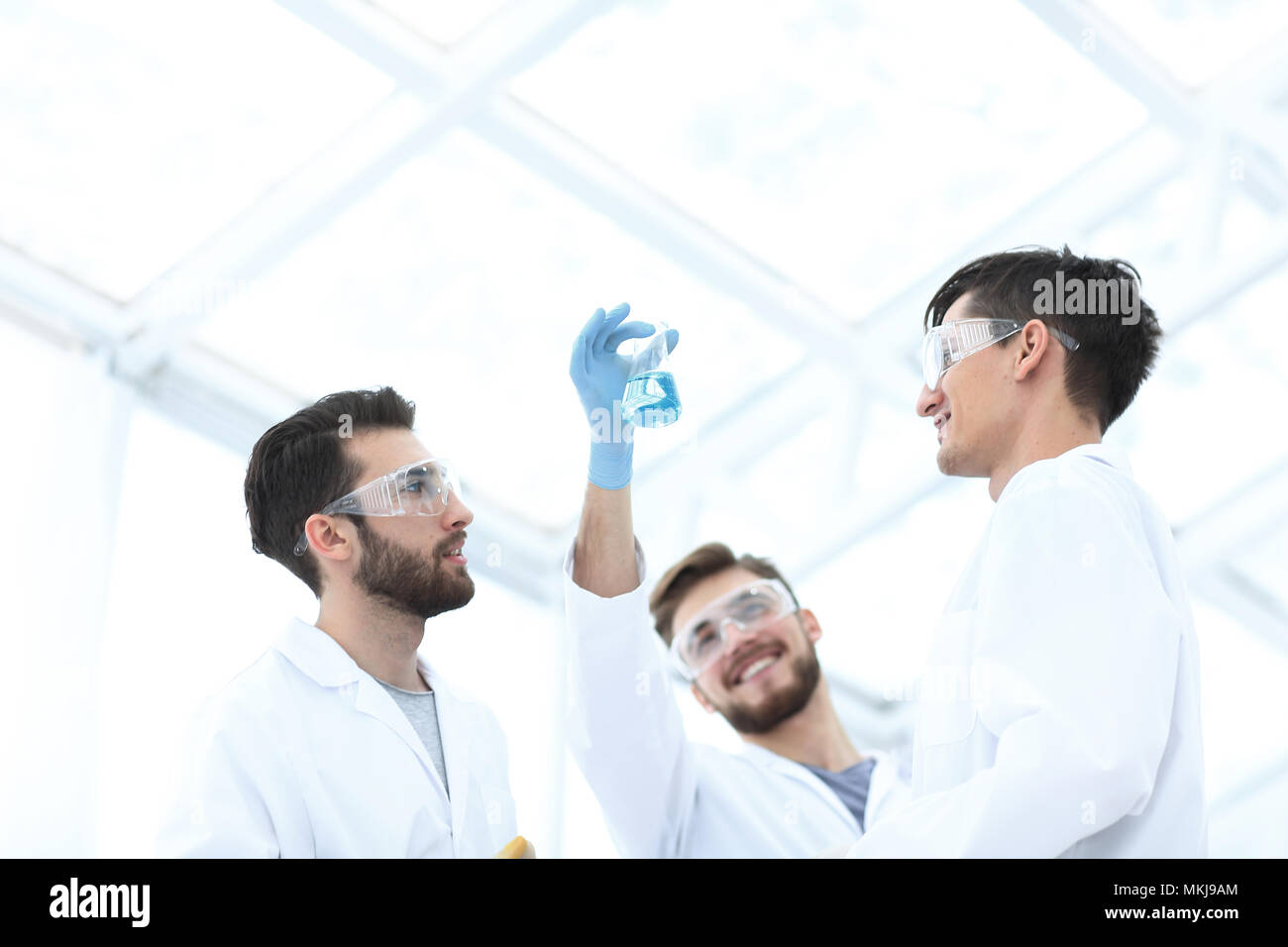 Scientists in lab looking beaker hi-res stock photography and images ...