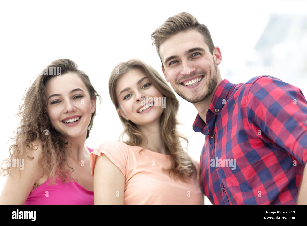 closeup of three young people smiling on white background Stock Photo ...