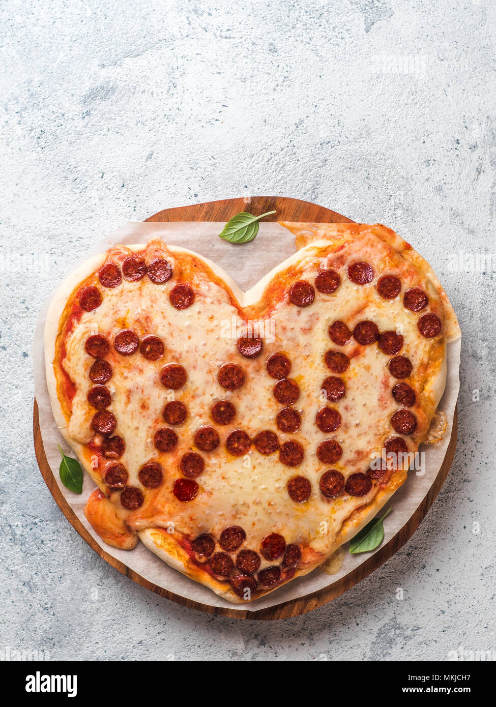 Pepperoni pizza in heart shape and dad word Stock Photo - Alamy