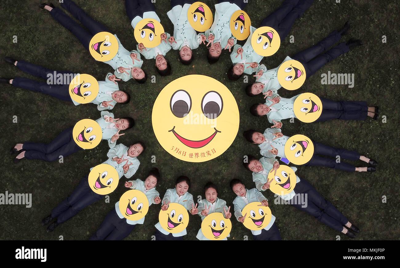 Yangzhou, China's Jiangsu Province. 8th May, 2018. Tour guides pose ...