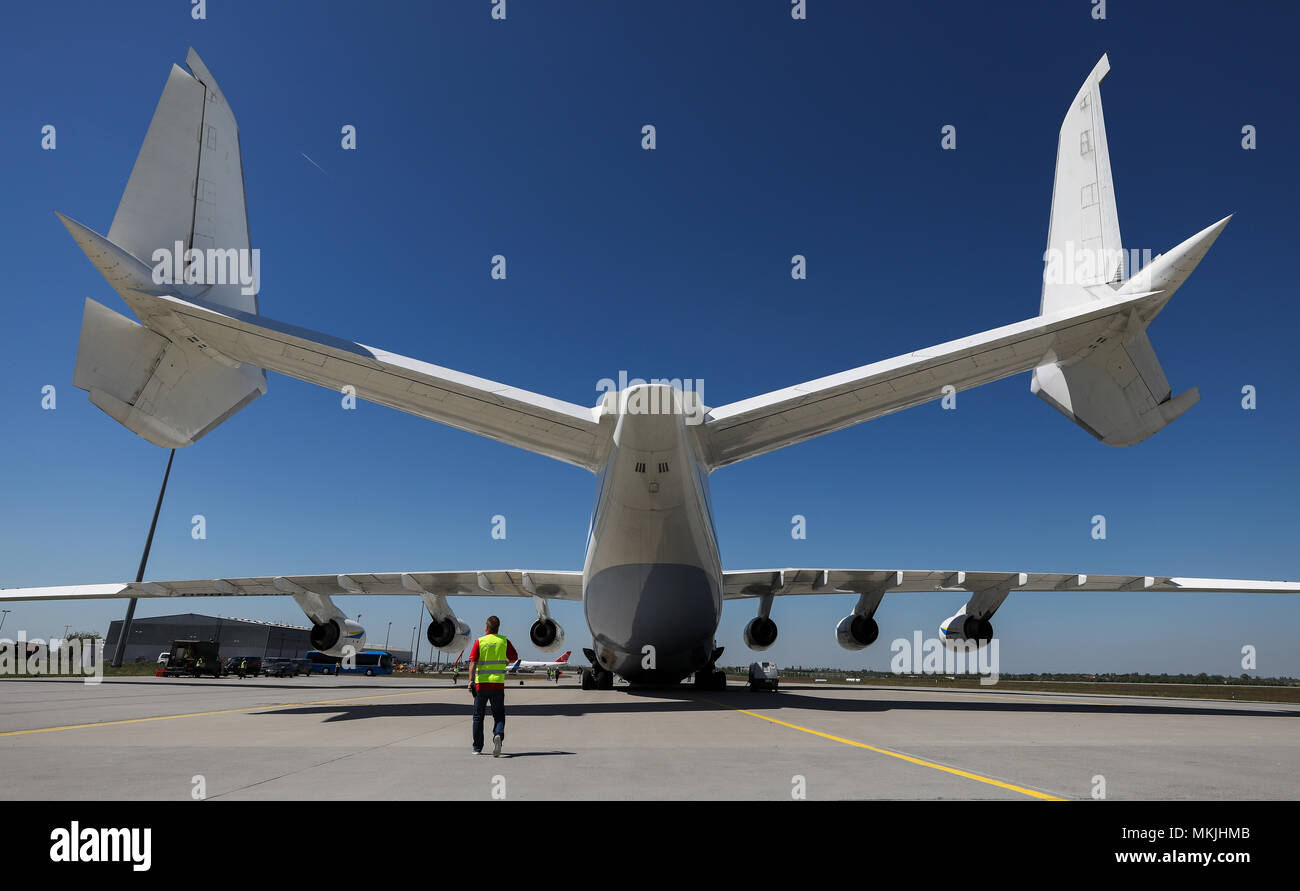 07 May 2018, Germany, Leipzig: A man walking under a Antonov 225. The ...