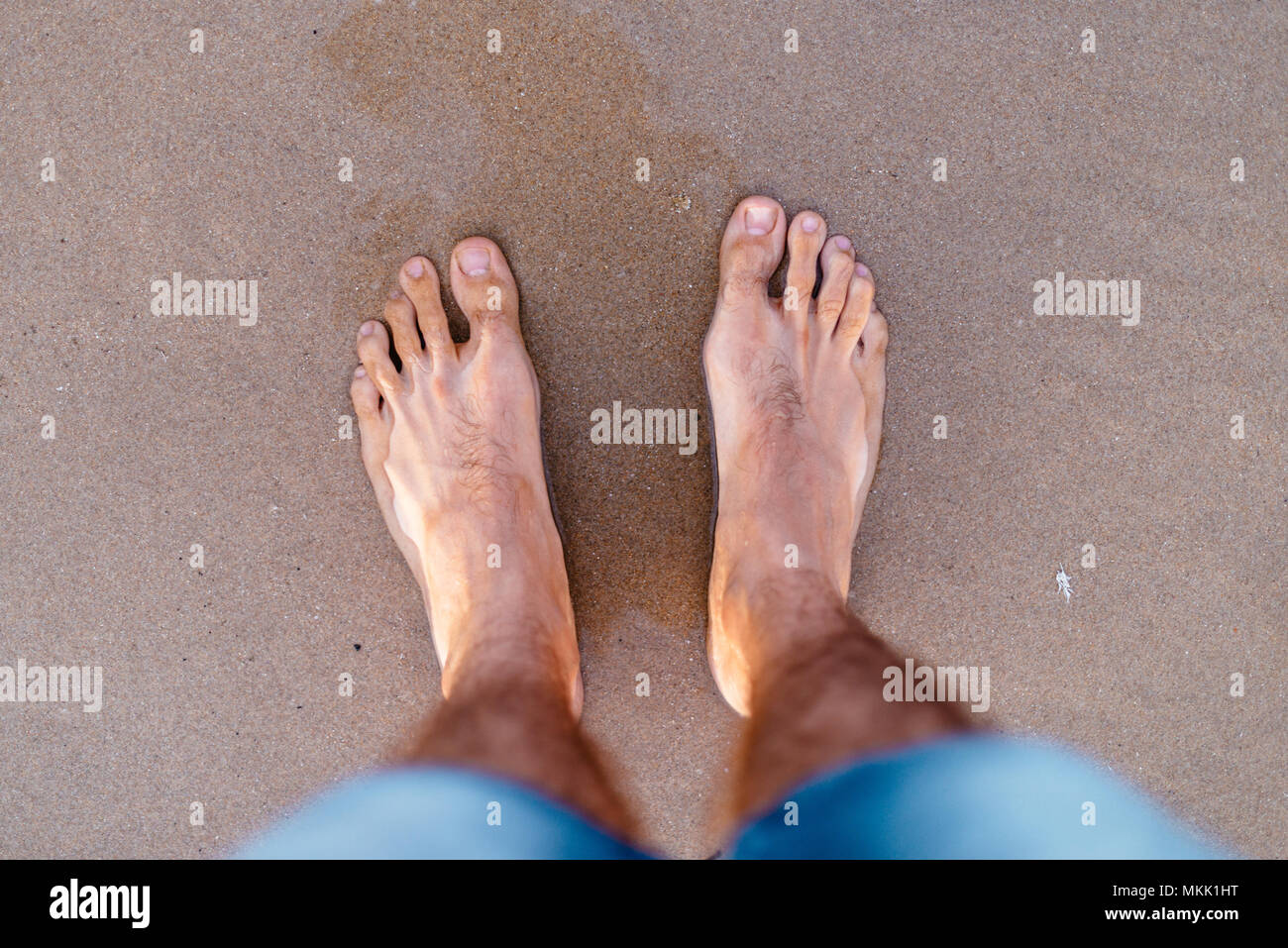Looking down at your feet on the beach Stock Photo - Alamy