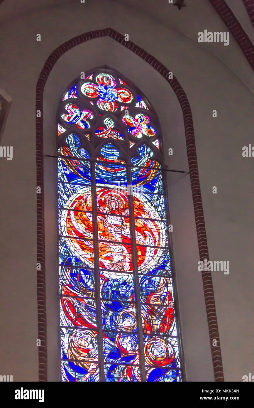 Interior of a brick cathedral in the Gothic style.A narrow high colored ...