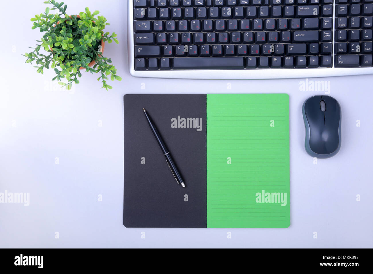 Office table with blank notepad and laptop, supplies and gadgets on ...