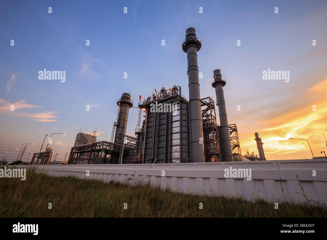 Gas combine electrical power plant at dusk with blue sky is support all ...