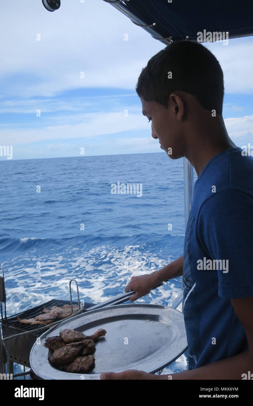 Ship's cook is making meal for tourist in a ship while sailing to an ...