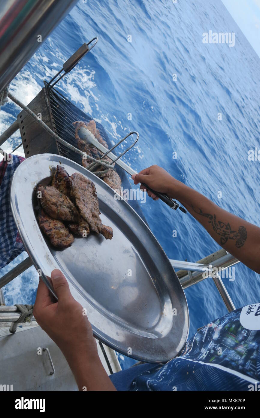 Ship's cook is making meal for tourist in a ship while sailing to an ...
