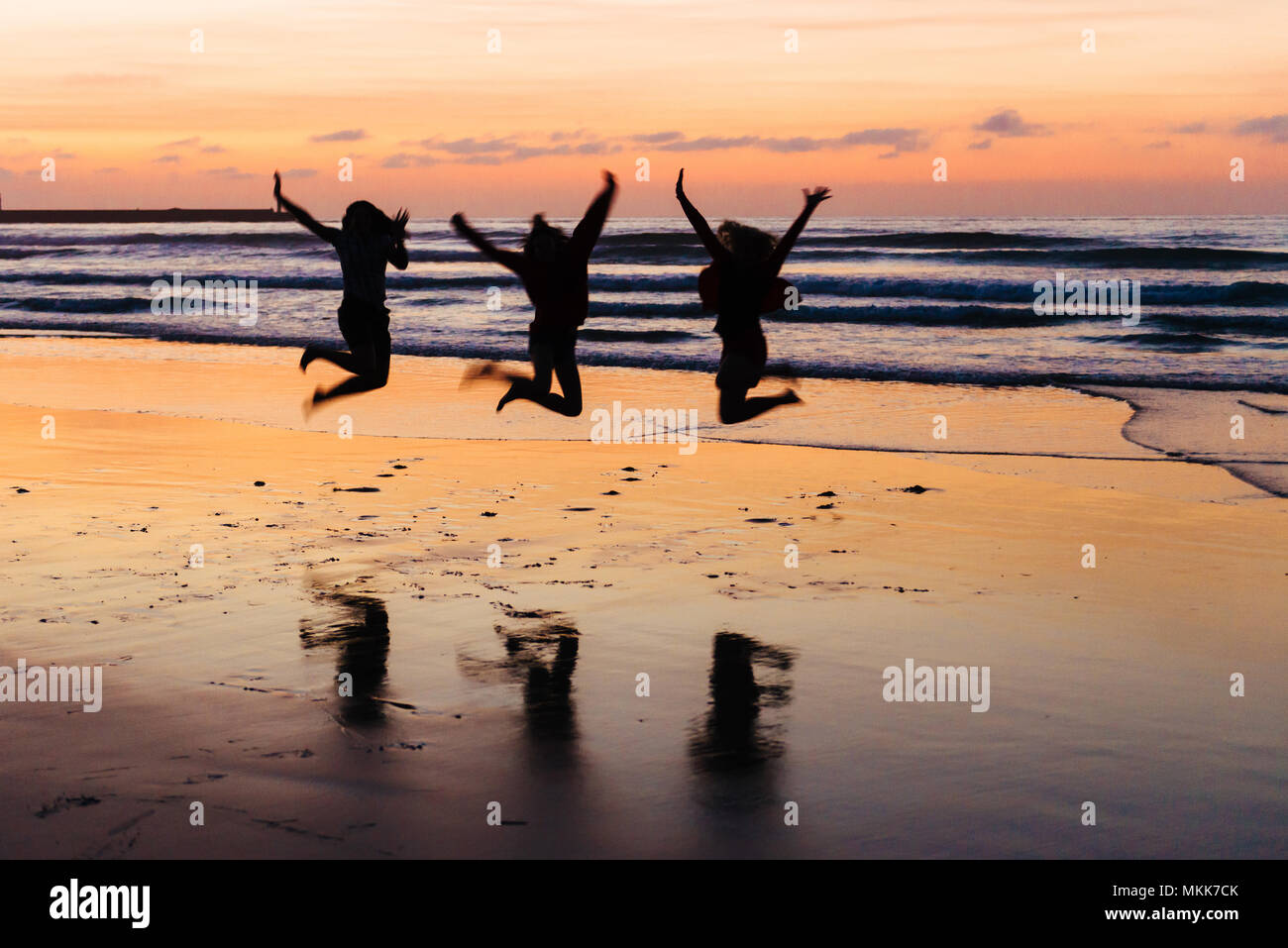 Three women on the beach hi-res stock photography and images - Alamy