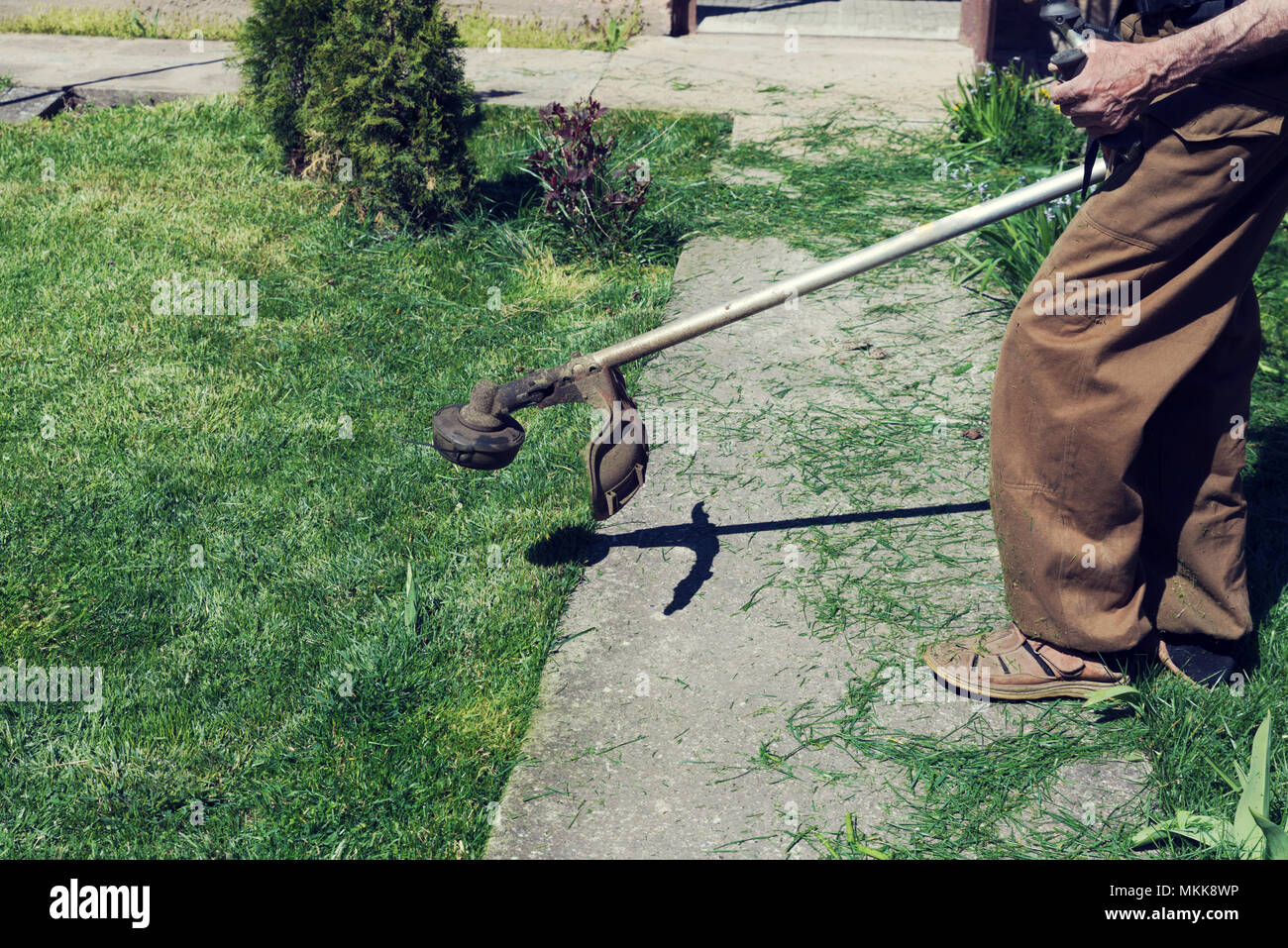 Cutting grass in spring Stock Photo - Alamy