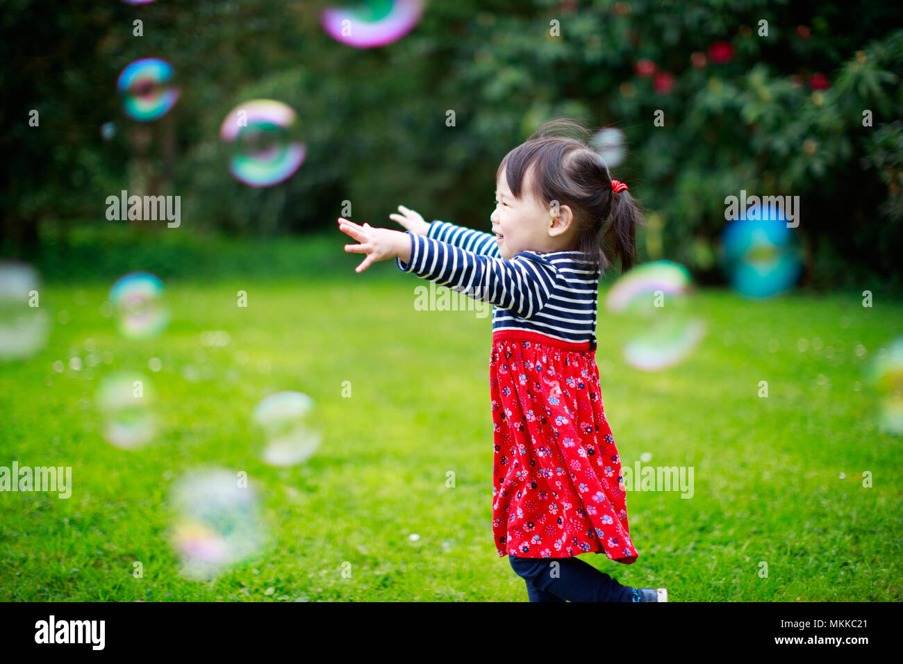 baby girl play bubble at spring garden Stock Photo - Alamy