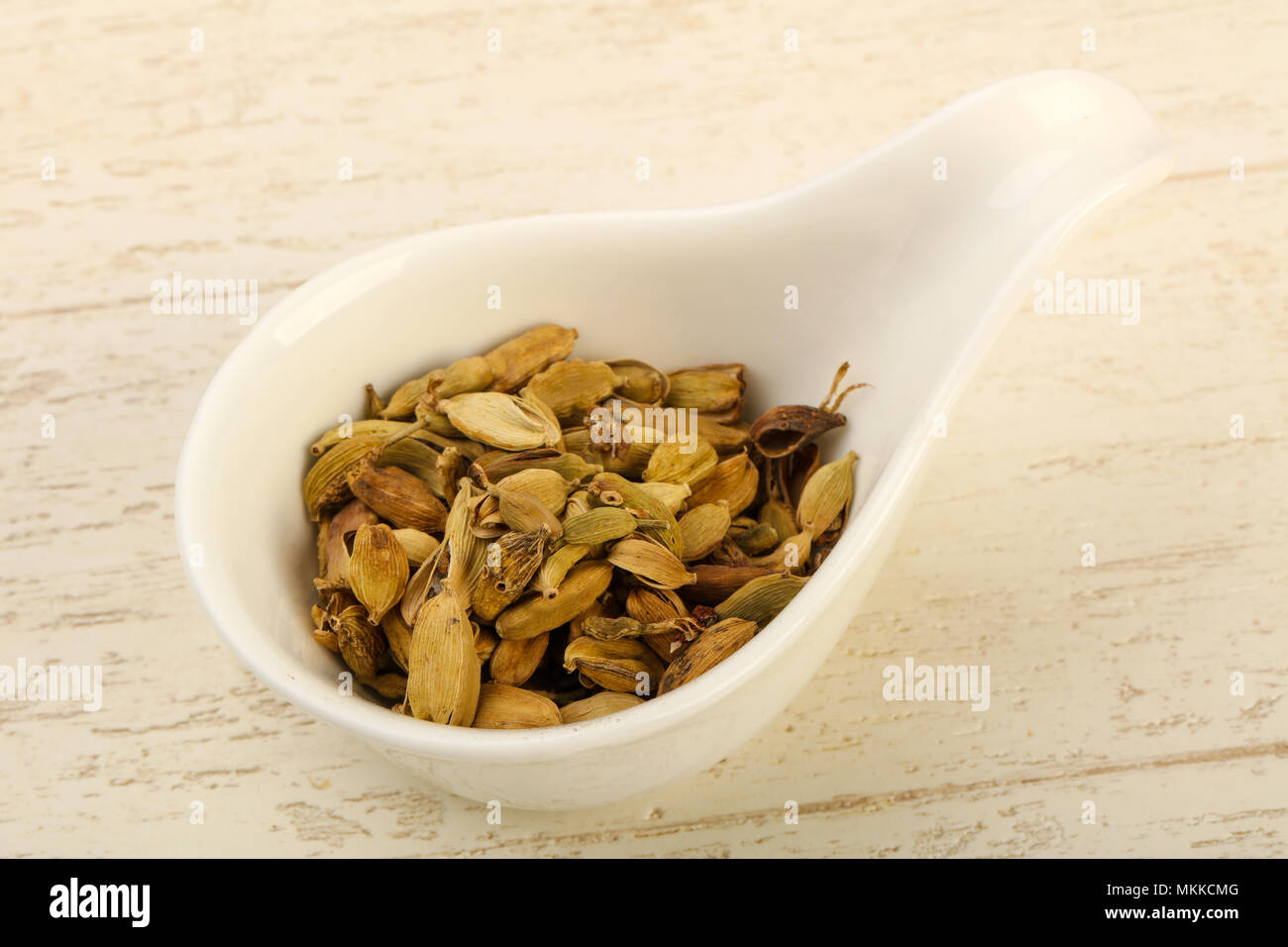 Dry cardamom seeds heap in the bowl Stock Photo - Alamy