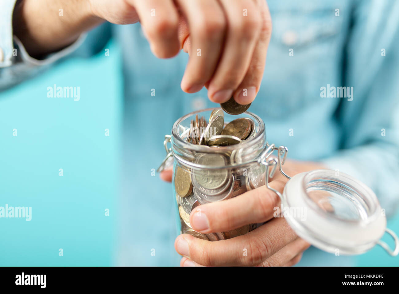Hand holding coins man hi-res stock photography and images - Alamy