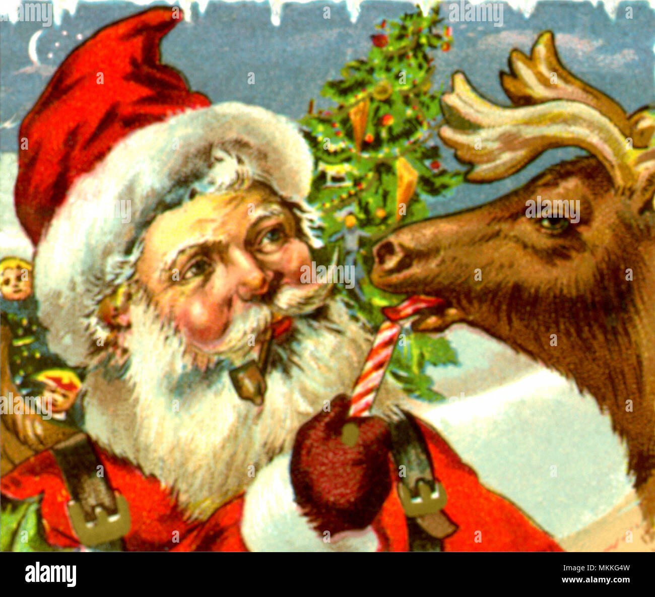 Santa Feeding Reindeer Stock Photo - Alamy