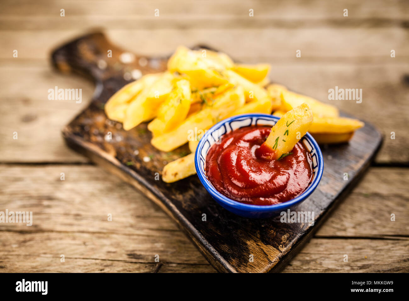 French fries on wooden table Stock Photo - Alamy