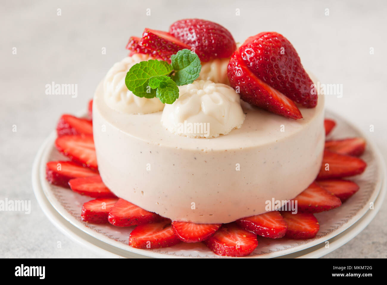 Light cheesecake with strawberry filling decorated with fresh berries ...