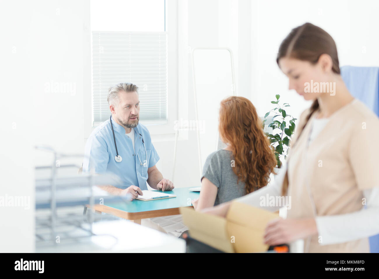 General practitioner in blue uniform with stethoscope during medical ...