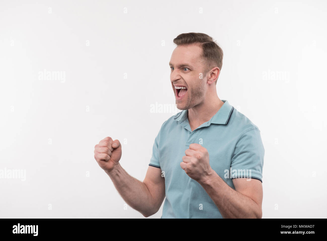 Delighted emotional man feeling happy Stock Photo - Alamy