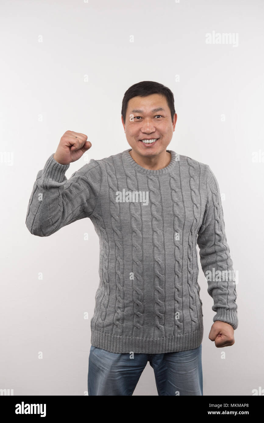 Delighted nice man holding his hand up Stock Photo - Alamy
