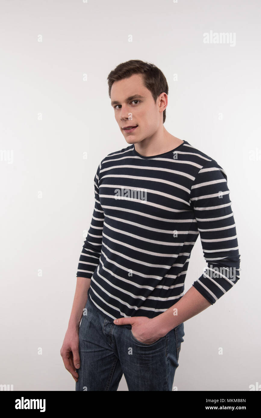 Handsome young man putting hand in his pocket Stock Photo - Alamy