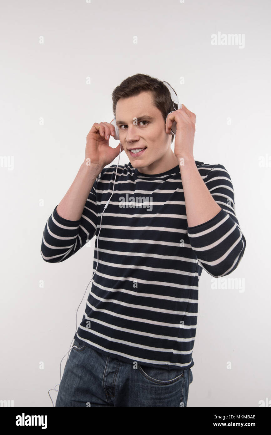 Happy millennial man listening hi-res stock photography and images - Alamy