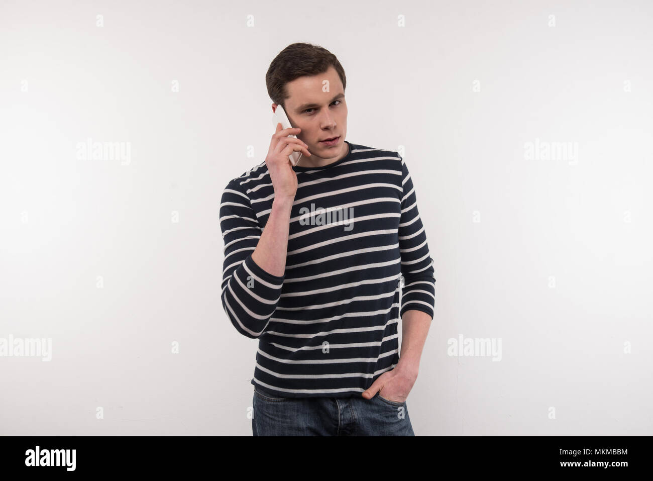 Handsome young man making a call Stock Photo - Alamy