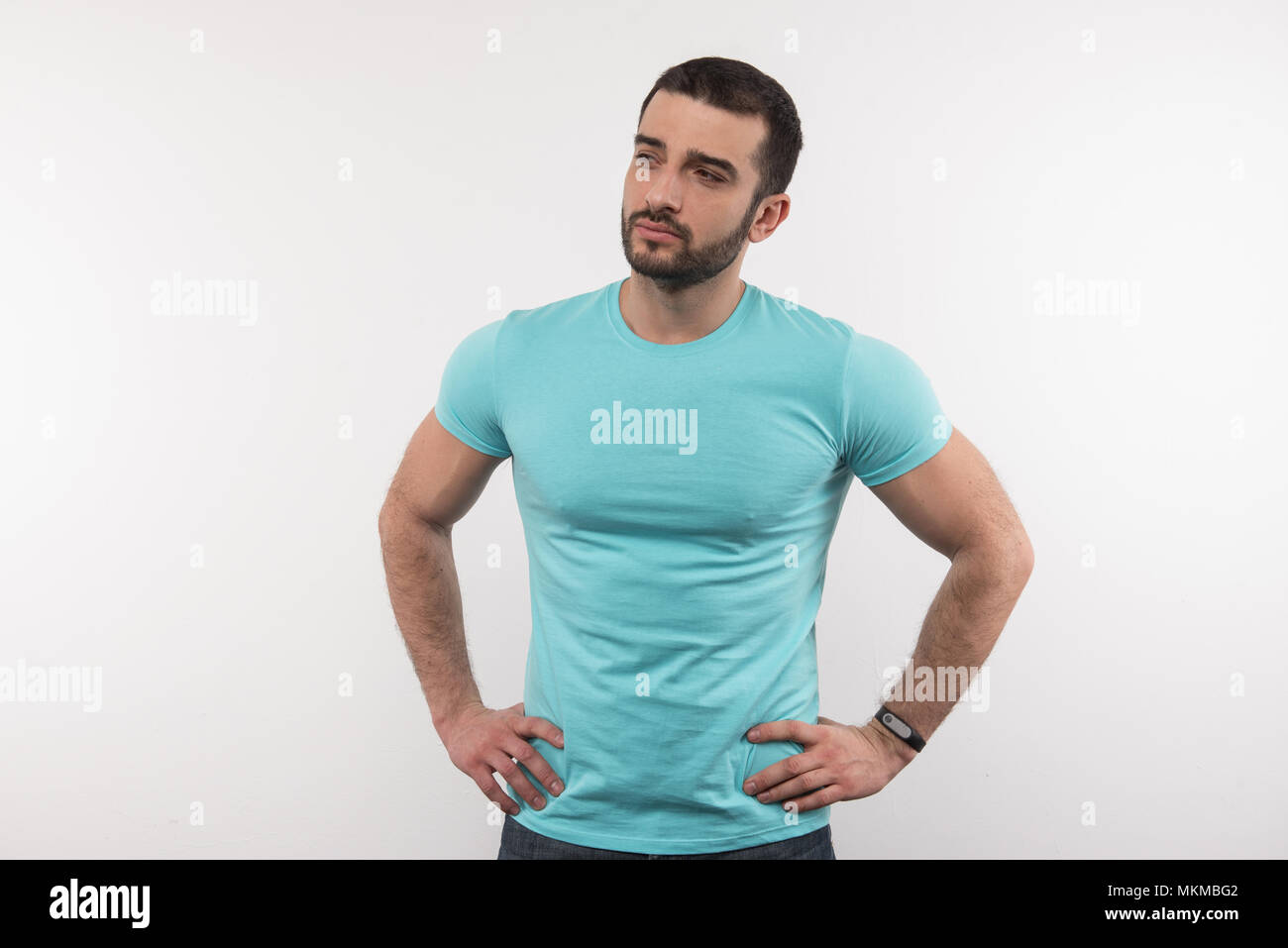 Strong nice man standing against white background Stock Photo - Alamy