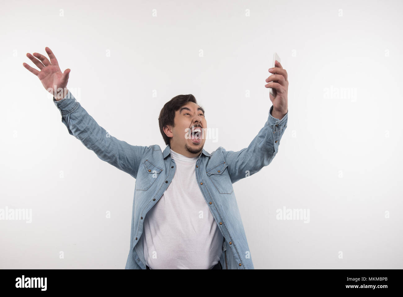 Happy nice man expressing his emotions Stock Photo - Alamy