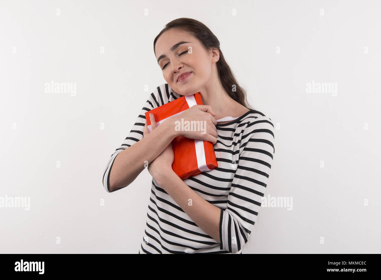 Happy joyful woman hugging the present Stock Photo - Alamy
