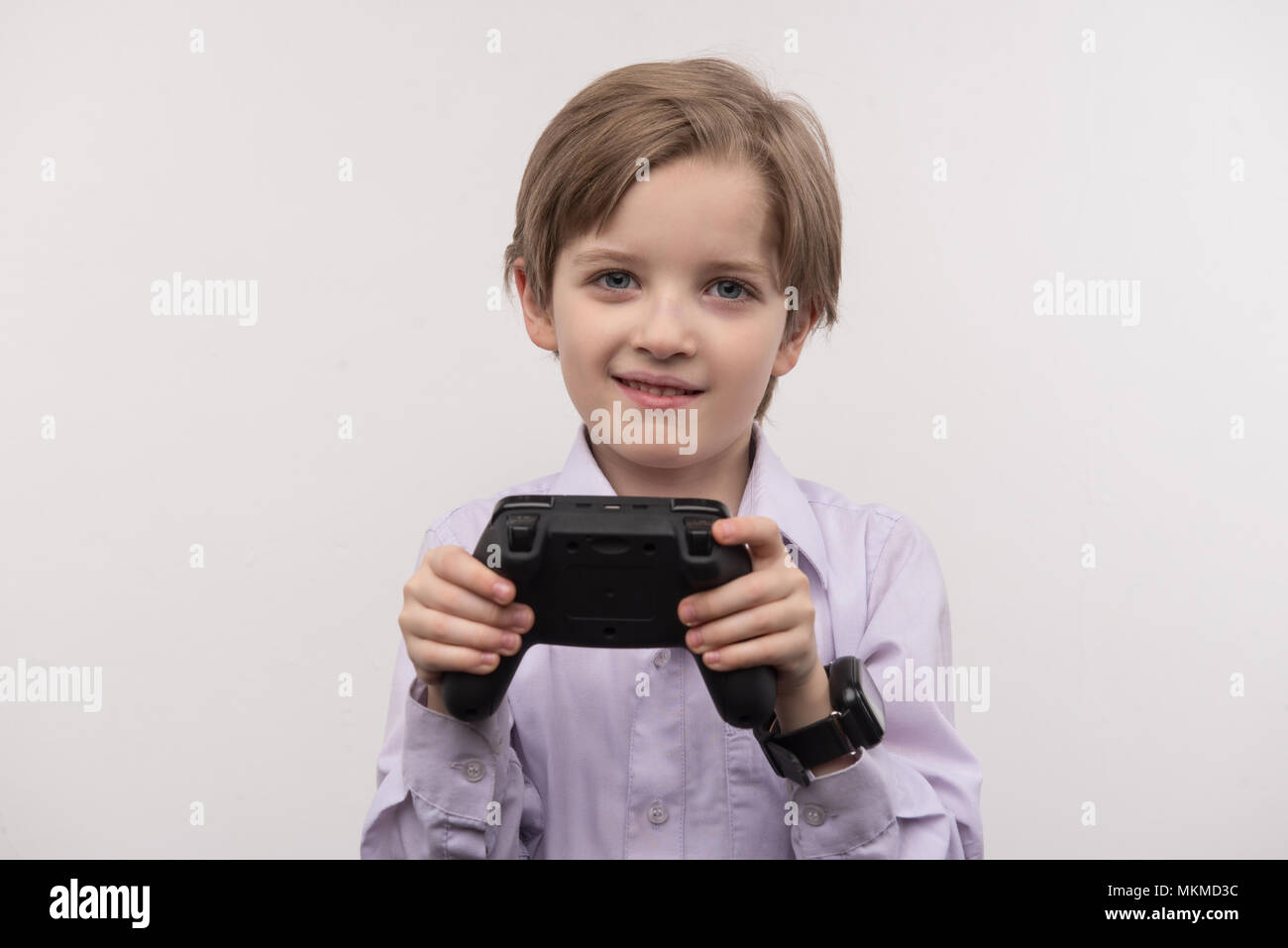 Happy delighted boy playing games Stock Photo - Alamy