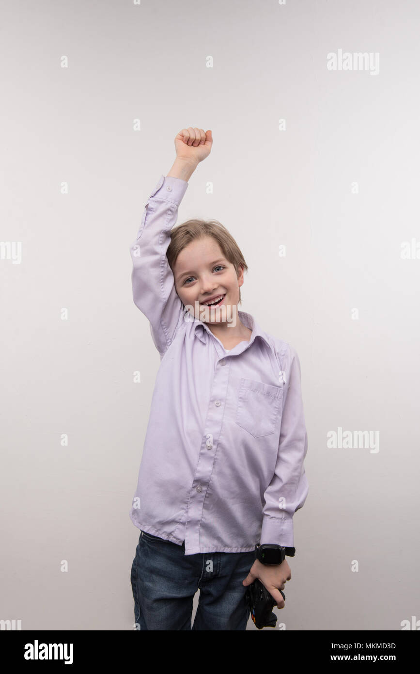 Joyful cute boy winning the game Stock Photo - Alamy