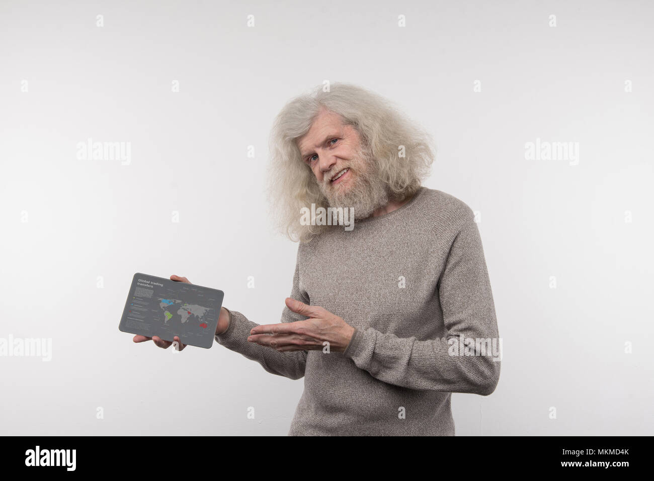 Positive joyful man holding a tablet Stock Photo - Alamy