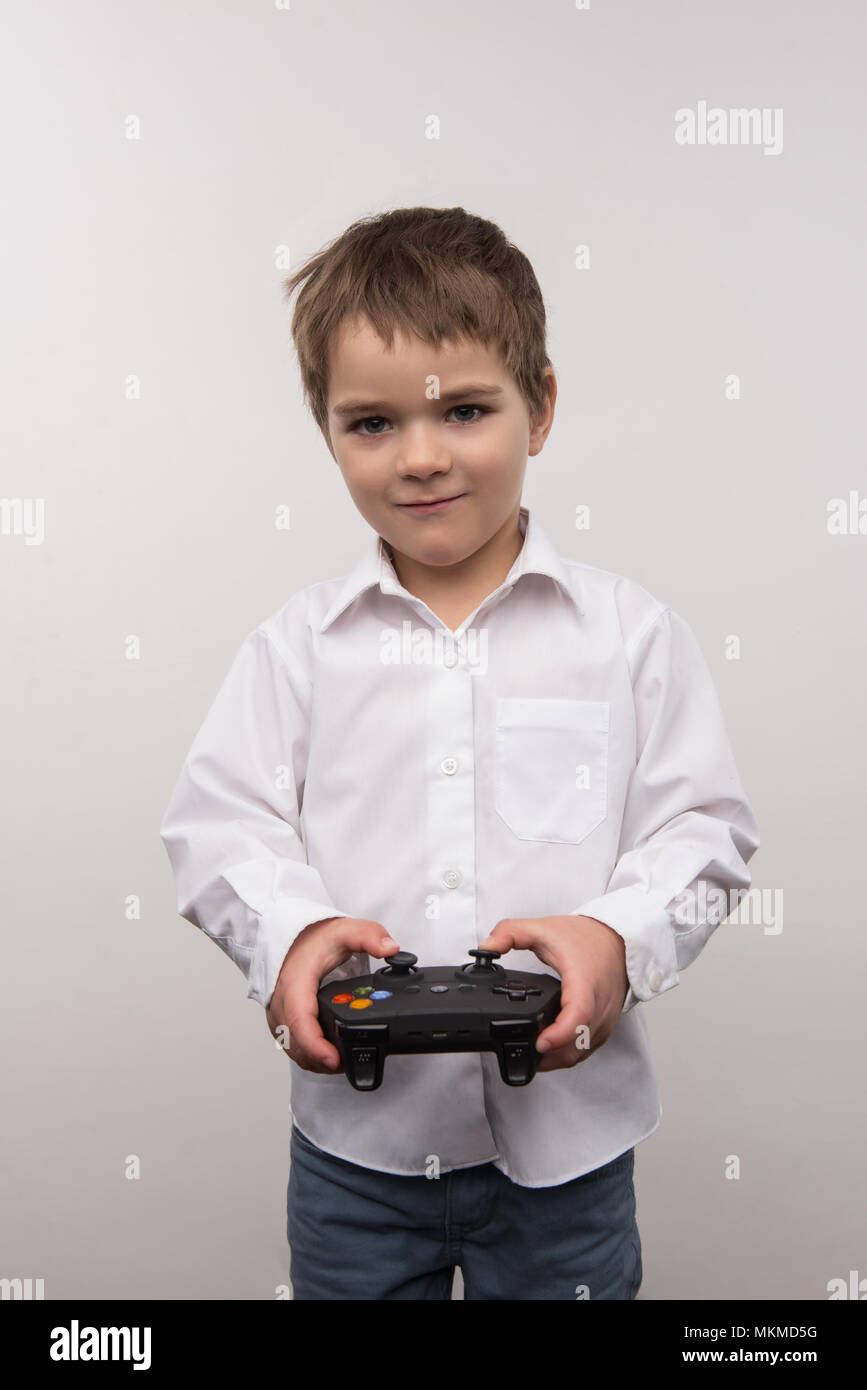 Joyful happy boy playing video games Stock Photo - Alamy