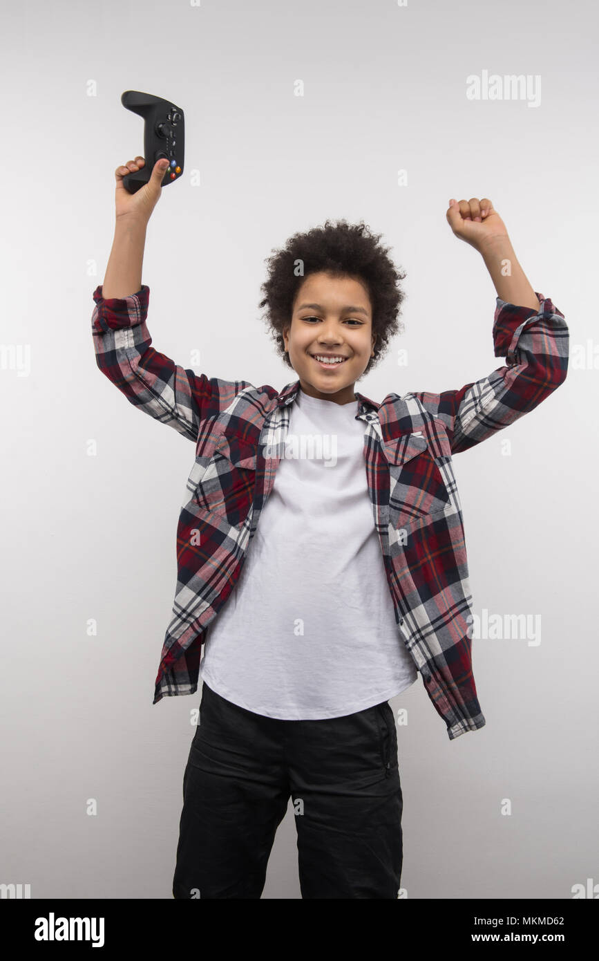 Happy cute boy winning the game Stock Photo - Alamy