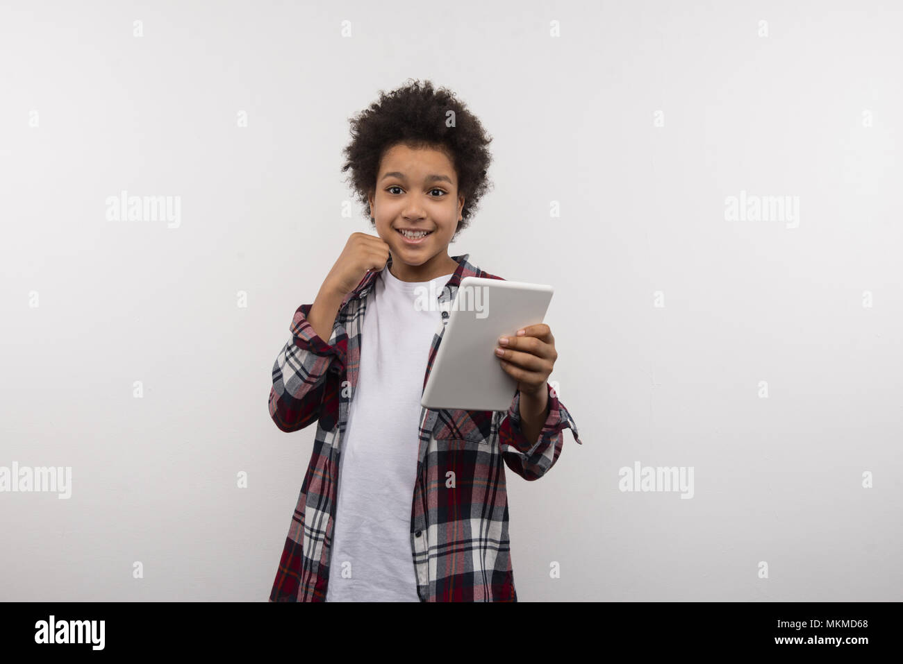Happy schoolboy holding digital hi-res stock photography and images - Alamy