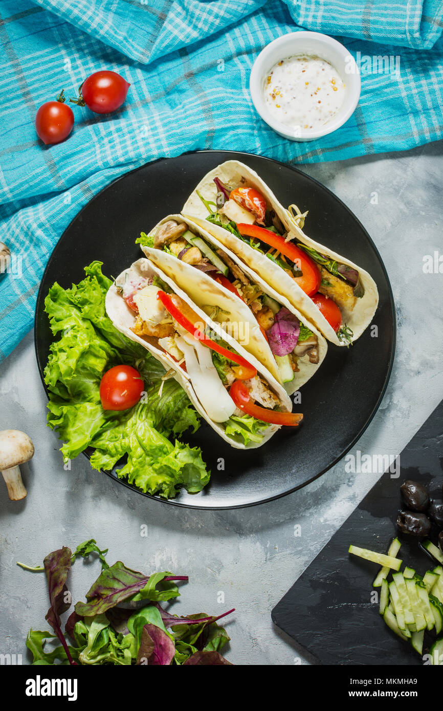 Fresh delicious mexican tacos and food ingredients on concrete rustic ...