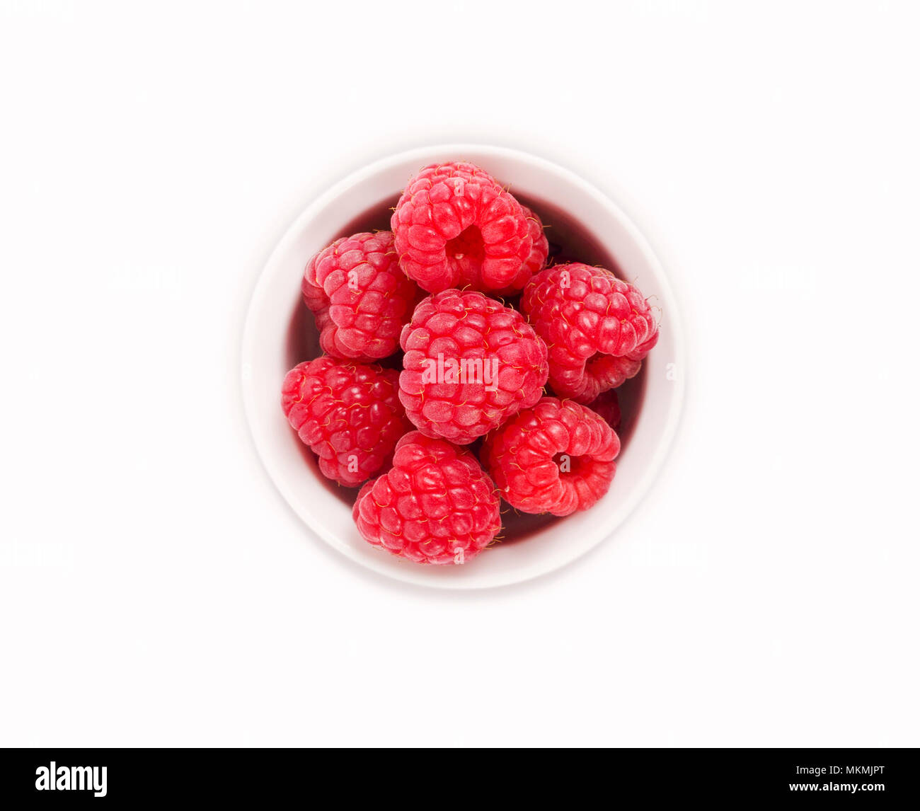 Raspberries in a white ceramic bowl. Ripe and tasty raspberries ...