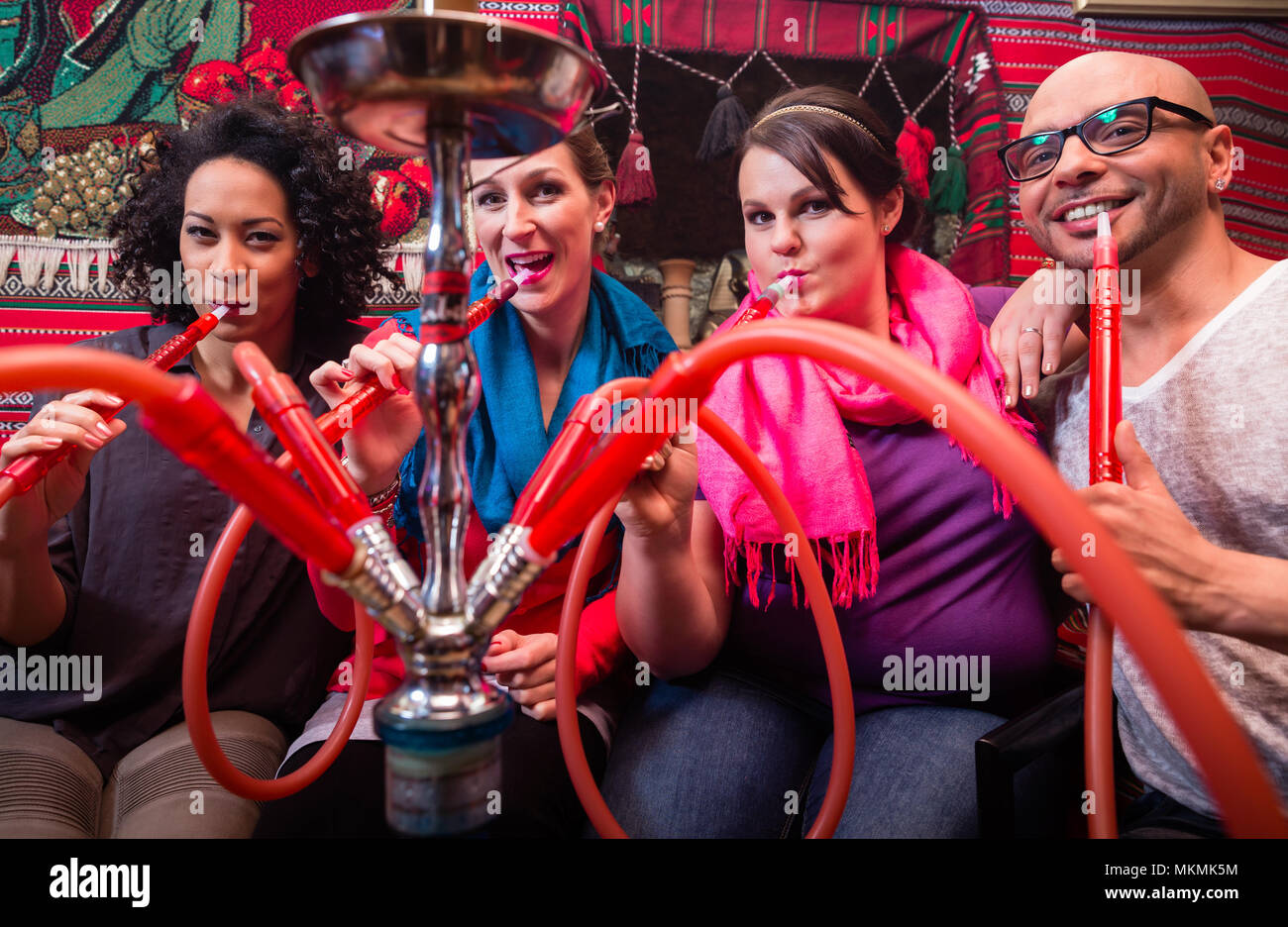 Beautiful young woman smoking shisha hi-res stock photography and ...