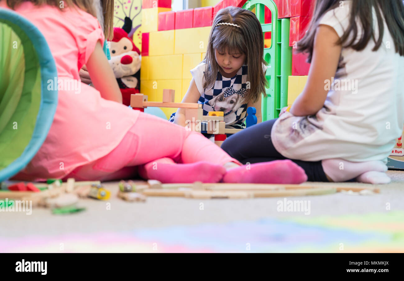 Cute girl building a structure from toy blocks during playtime Stock ...